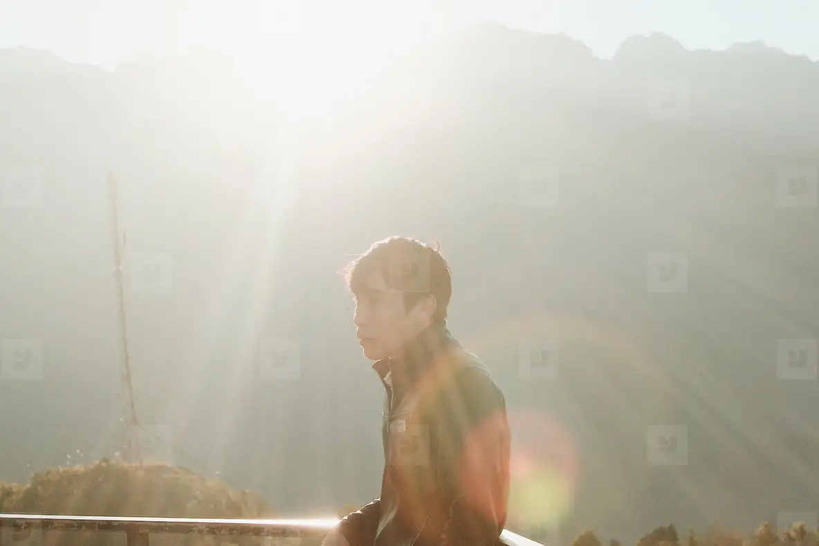Young Man Standing With Sunlight Photo (103451) - YouWorkForThem