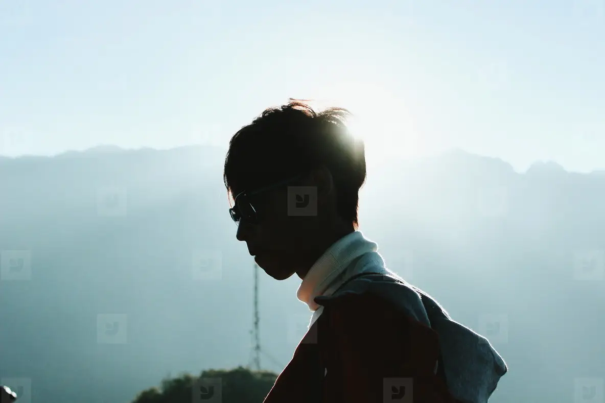 Young Man Standing With Sunlight Photo (103452) - YouWorkForThem