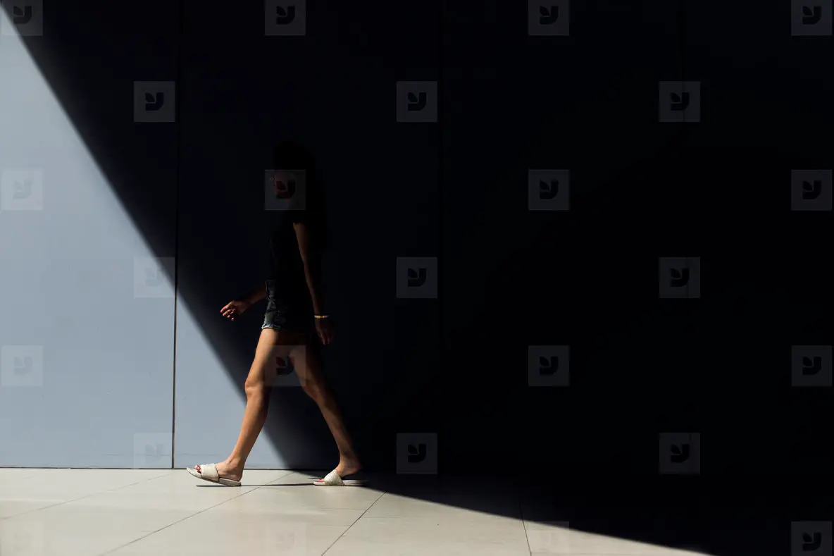 Woman Walking Between Shadow Photo (112032) - YouWorkForThem