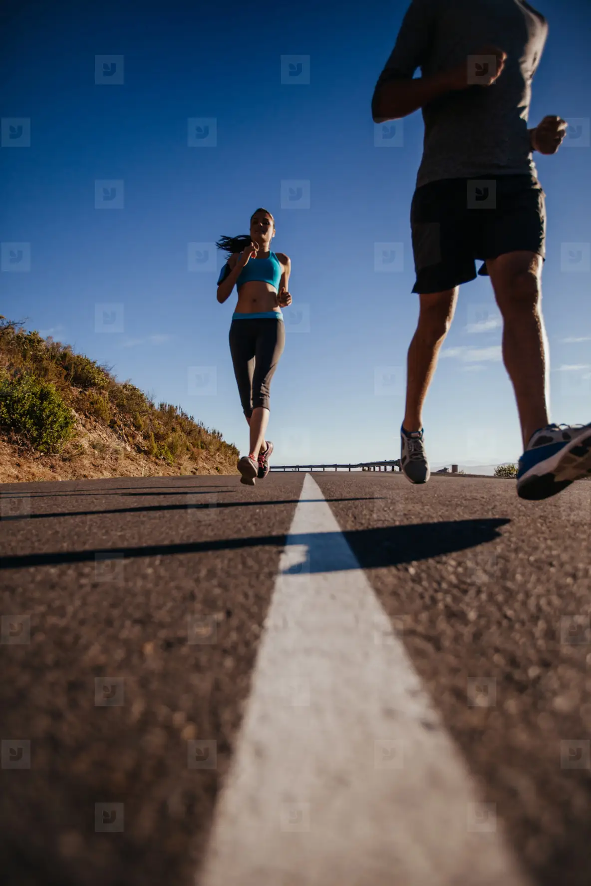 Woman Running On Road With Man In Front Photo (122167) - YouWorkForThem
