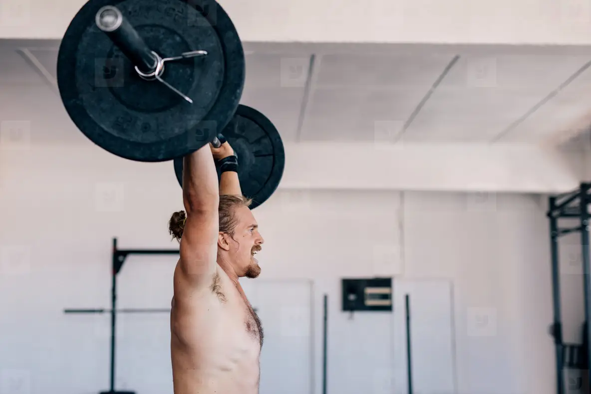 Muscular Man Lifting Heavy Barbell At Gym Photo (126703) - YouWorkForThem