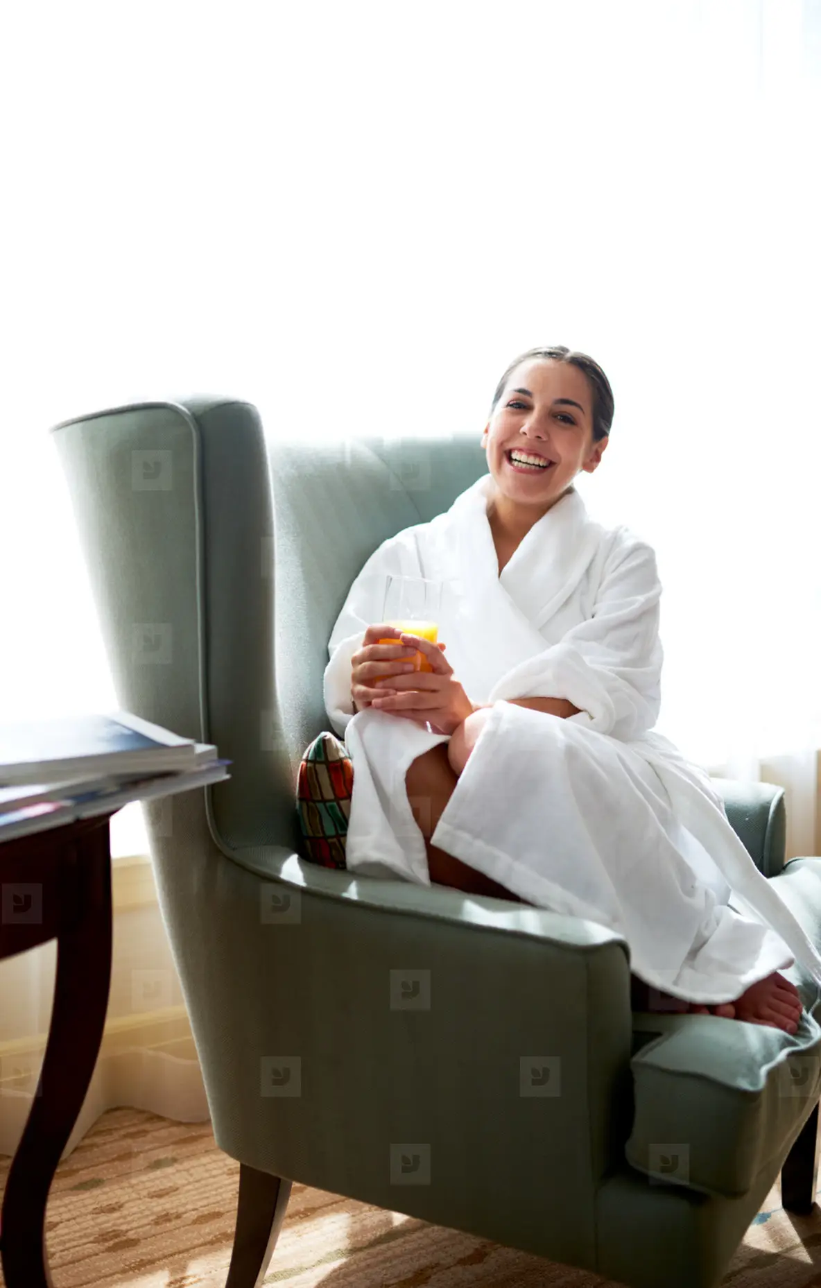 Woman Curled Up In Chair Smiling Widely Photo (154313) - YouWorkForThem
