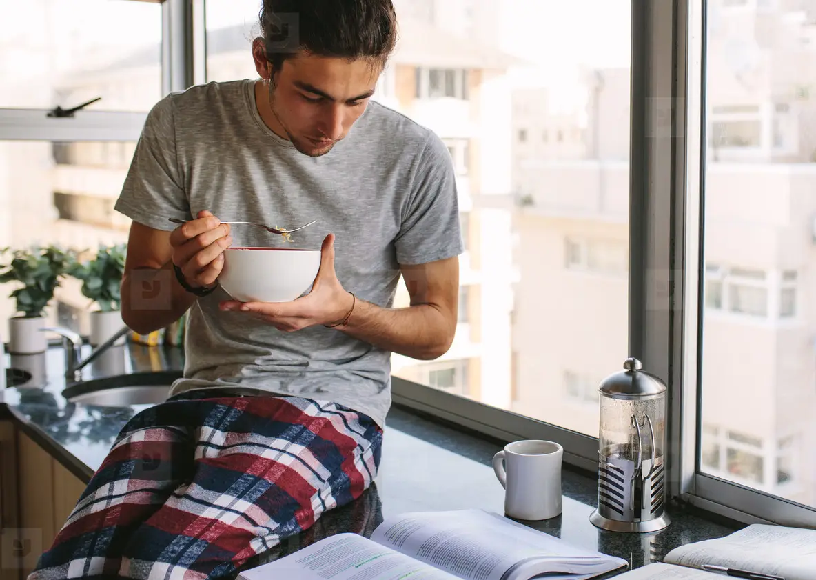 Student Eating Food While Studying Photo (155887) - YouWorkForThem