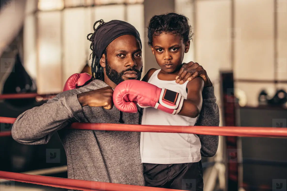 Boxing Trainer With A Kid Boxer Standing Inside A Boxing Ring Photo ...