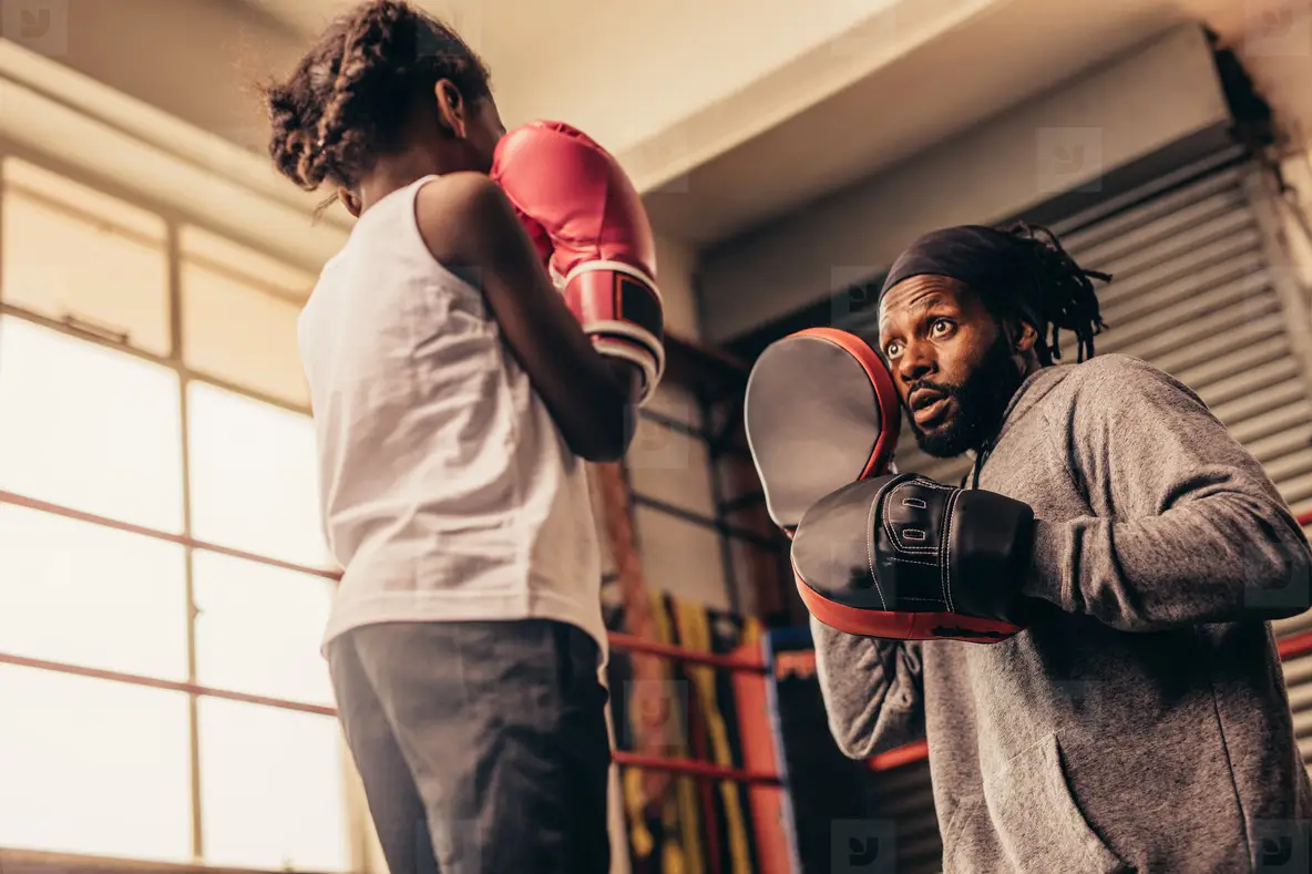 Low Angle View Of A Boxing Girl Training With Her Coach Photo (156254 ...