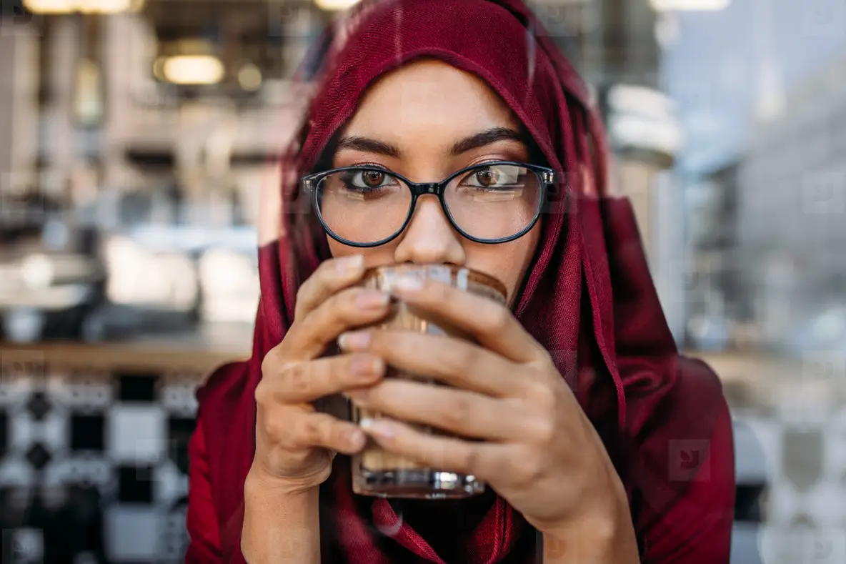 Muslim Woman Having Coffee At Cafe Photo (163039) - YouWorkForThem