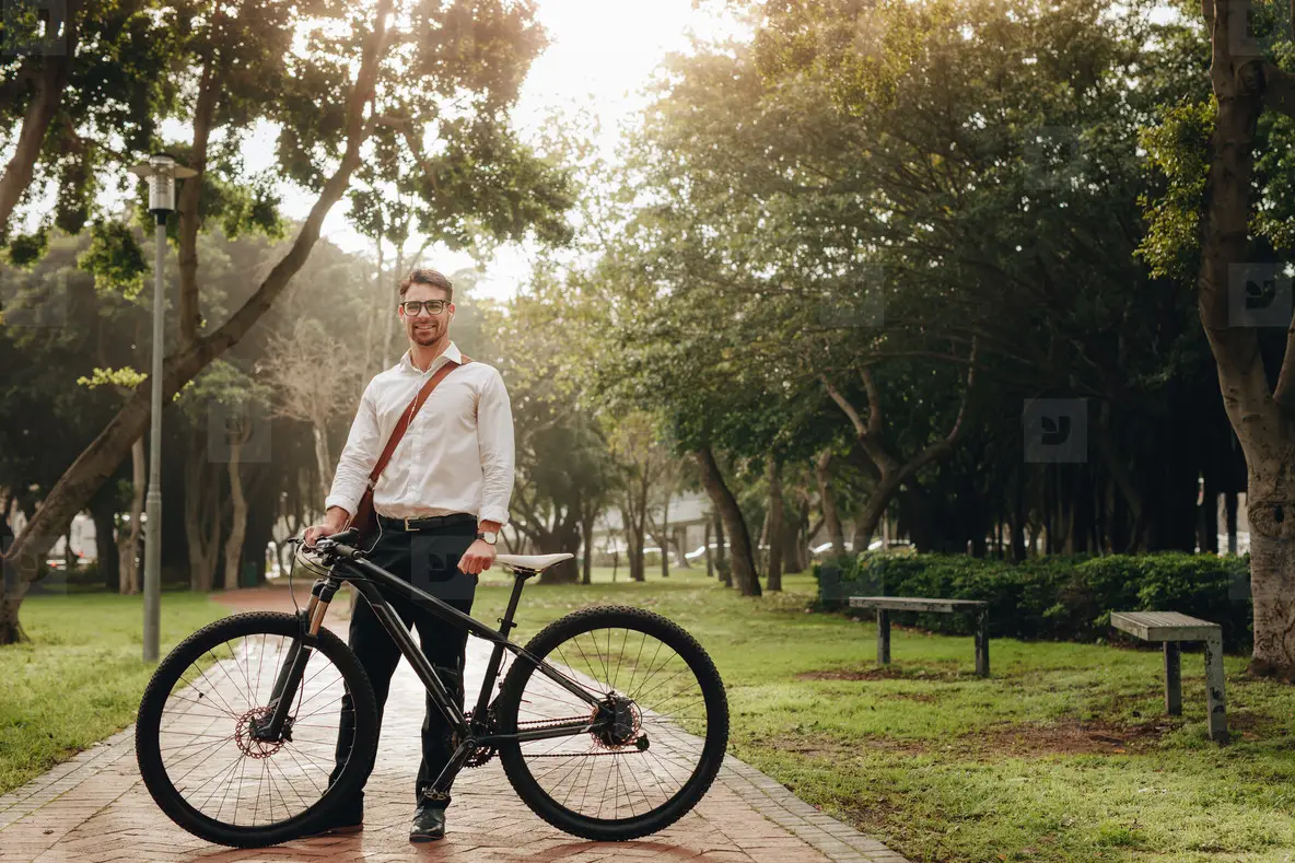 Man Standing In Park With His Bike Photo (164753) - YouWorkForThem