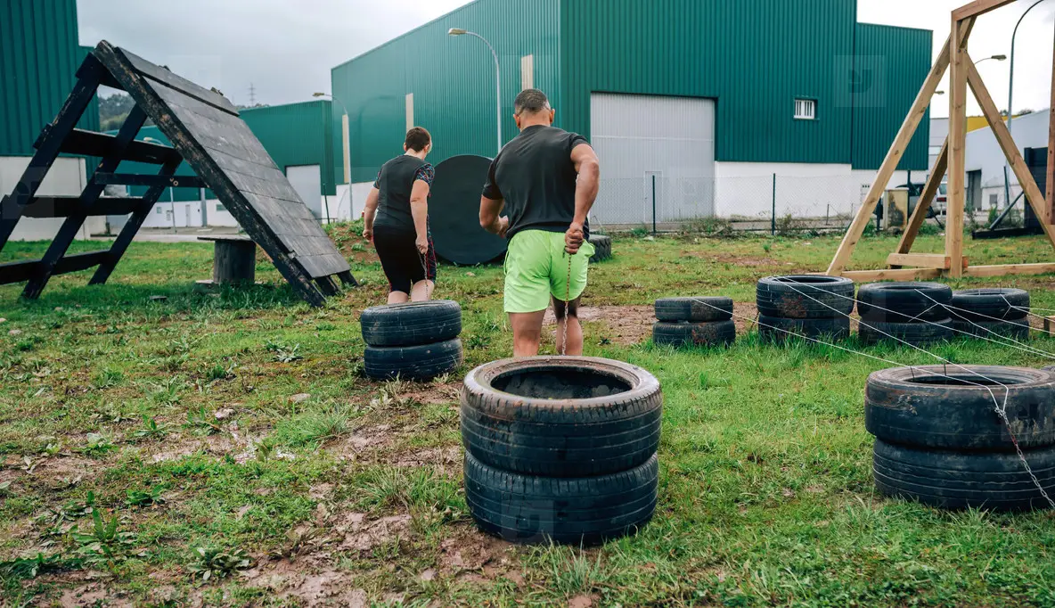 Participants In An Obstacle Course Dragging Wheels Photo (200973 ...