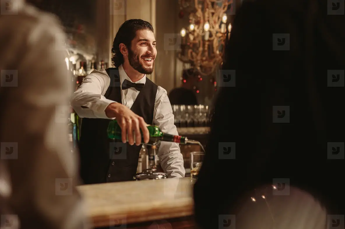 Bartender Serving Drink To Guest At Bar Photo (209624) - YouWorkForThem