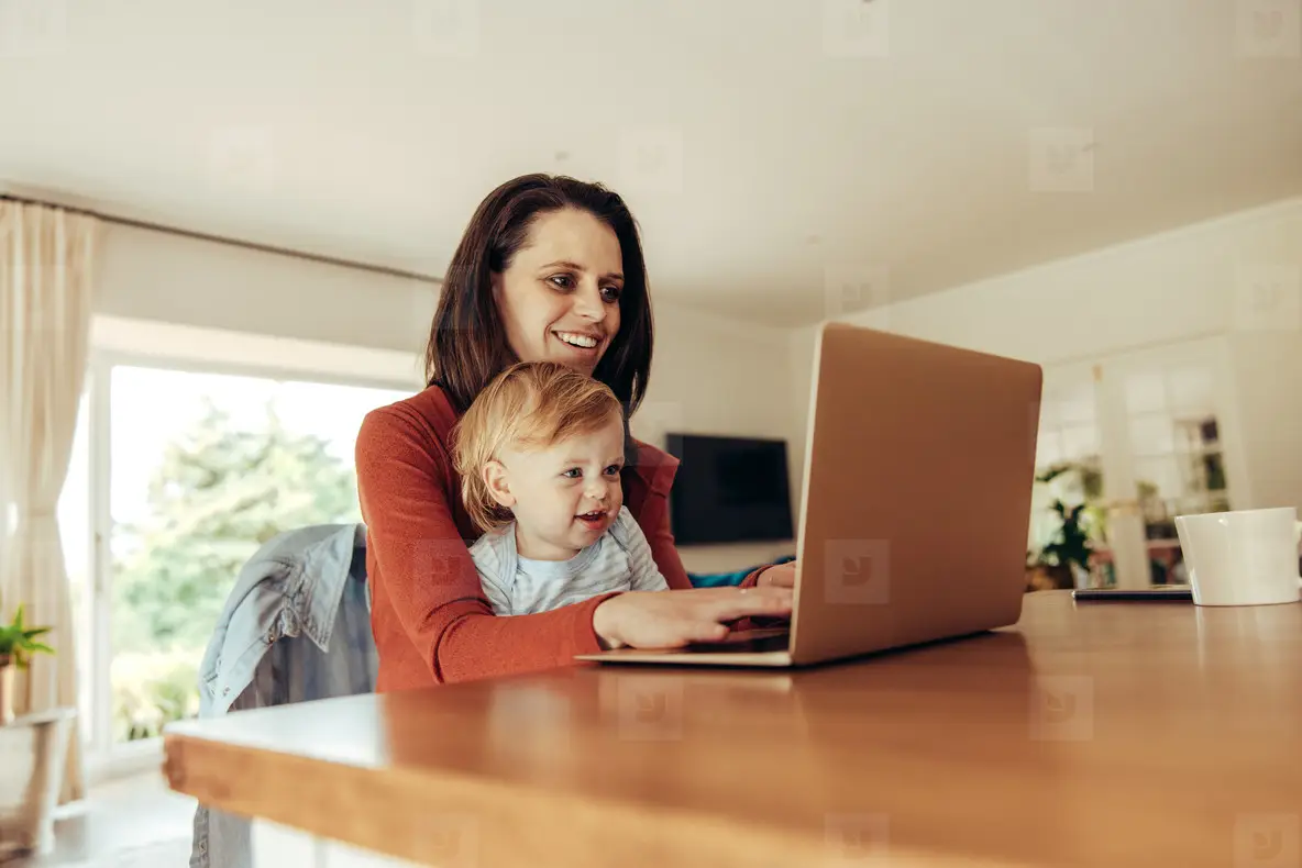 Woman With Baby Working On Laptop Photo (225387) - YouWorkForThem