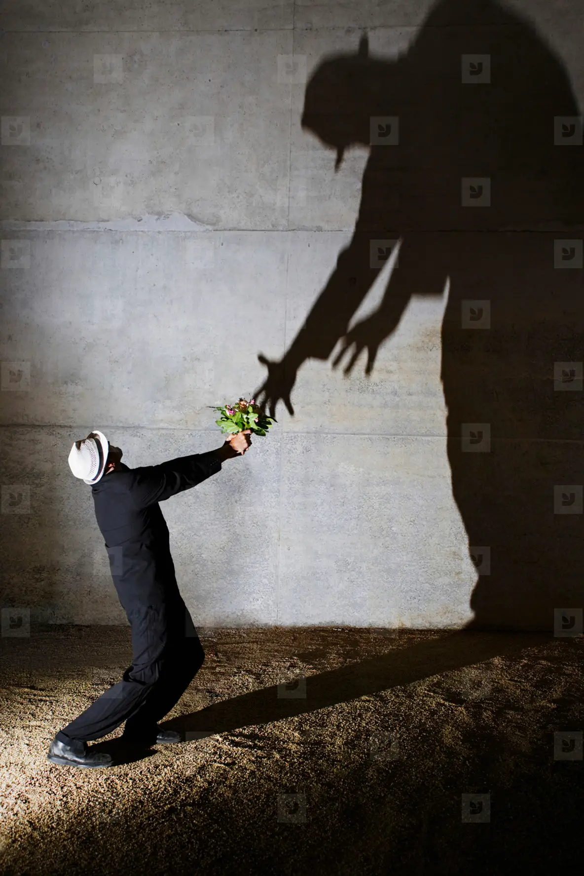 Man Offering Flowers To Tall Ominous Shadow On Wall Photo (233388 ...