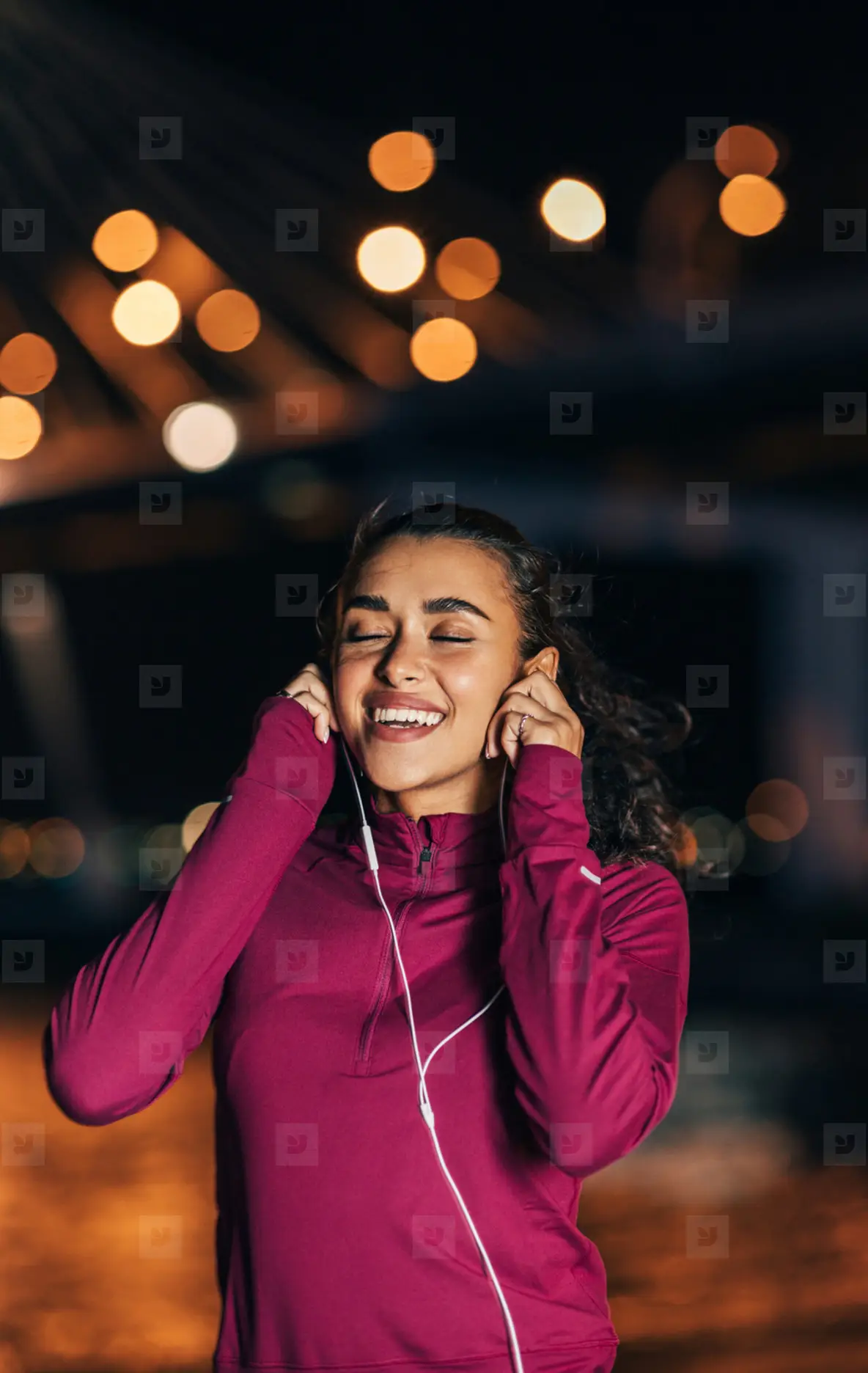Female Runner Listening To Music On Earphones At Night Photo (234000 ...