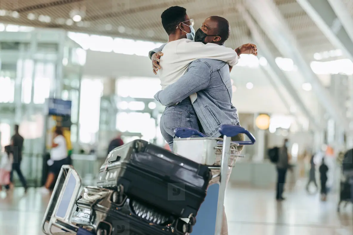 Man Hugging Woman At Airport Terminal Photo (235223) - YouWorkForThem