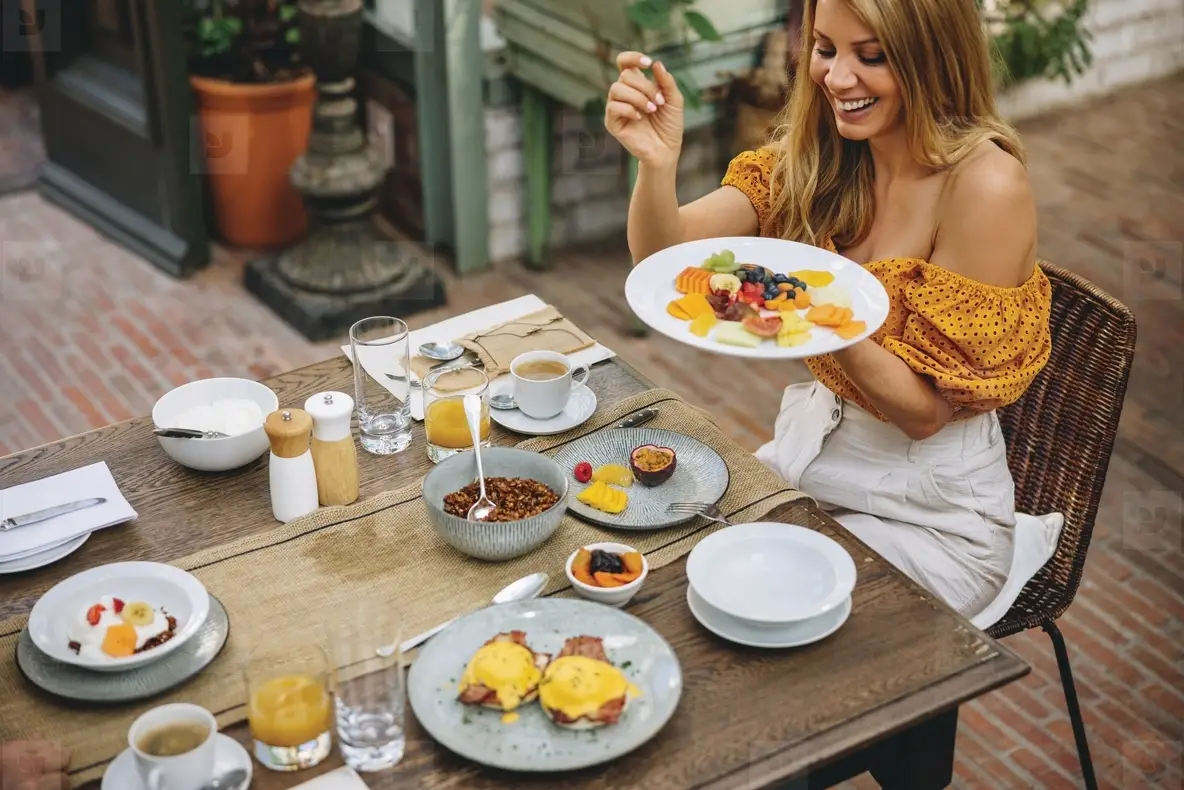 Cheerful Woman Enjoying A Healthy Breakfast At A Luxury Hotel Photo ...