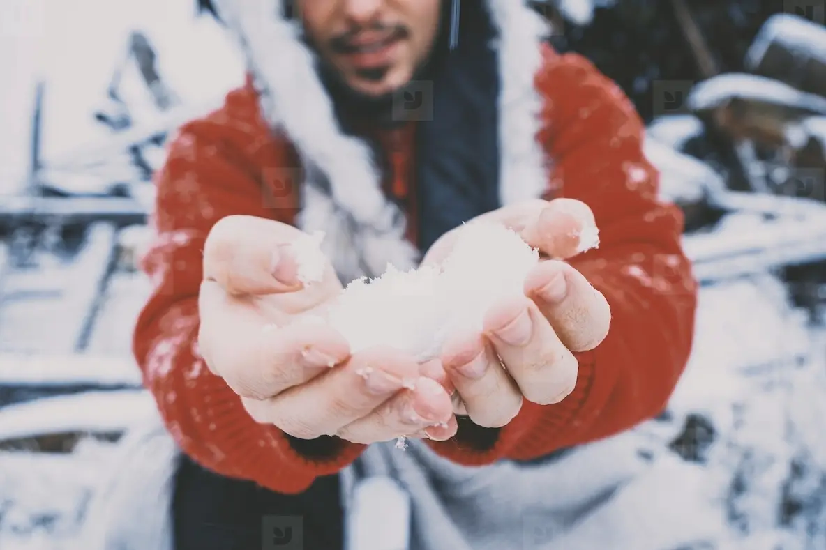 Young Man Enjoying A Snowy Day Wearing A Fur Hat And A Red Hoodi Photo ...