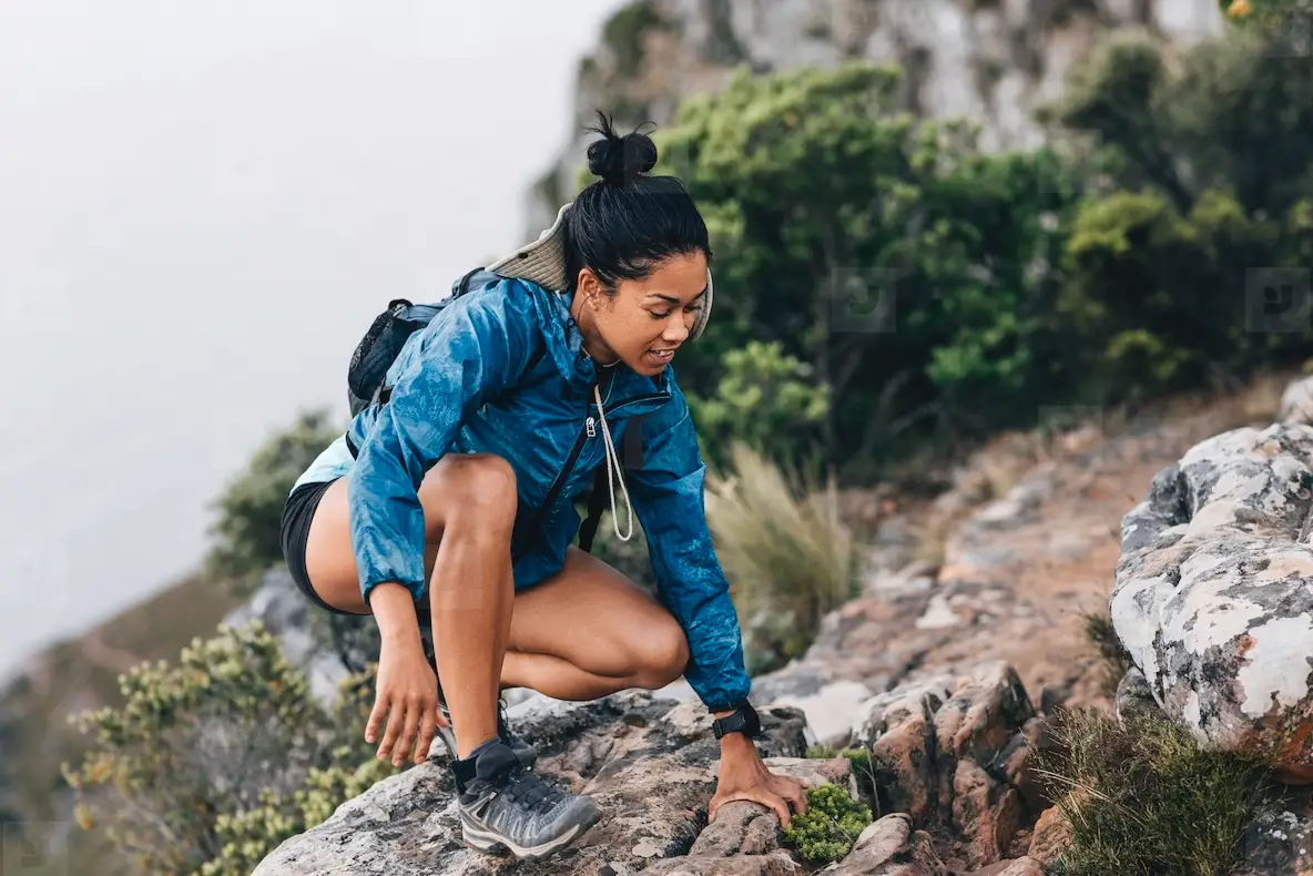 Smiling Woman Climbing Up On A Mountain. Female Hiker Sitting On A ...