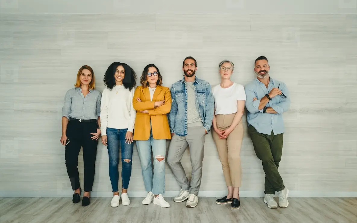 Group Of Creative Businesspeople Standing Against A Wall Photo (255784 ...