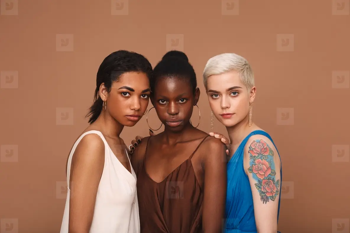 Group Of Three Women Of Different Races Standing Together Against Brown ...