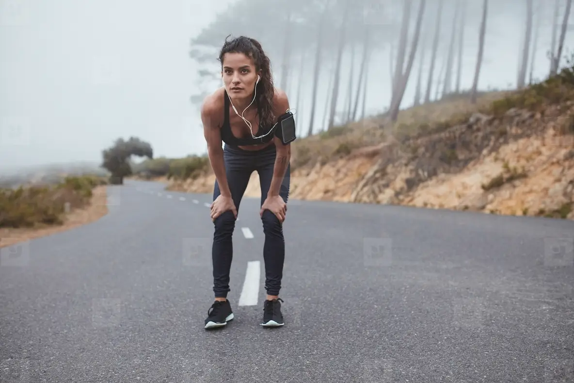 Young Woman Taking A Break From Running On The Road Photo (262803 ...