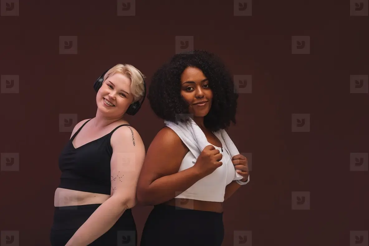 Two Plus Size Woman Standing Back To Back Against Brown Background And ...