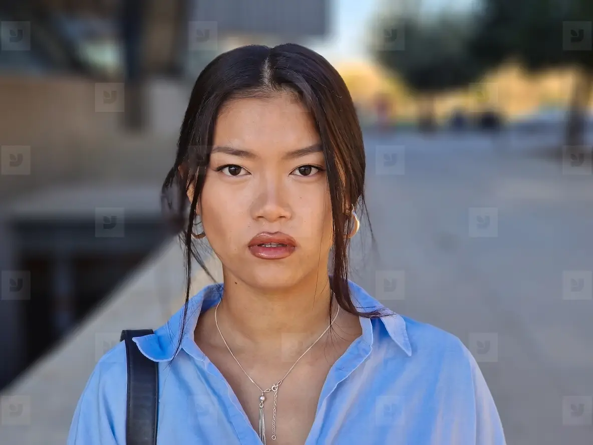 Chinese Girl Looking At Camera With A Serious Expression In Urban ...