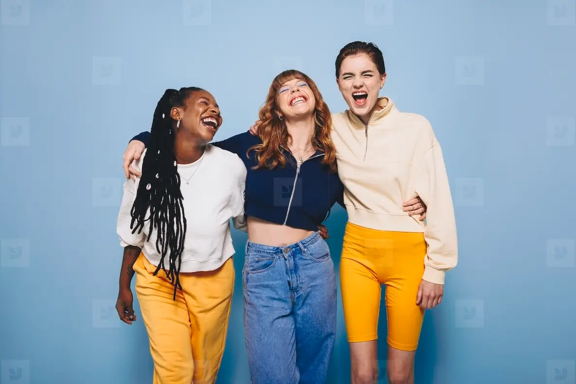 Three Best Friends Laughing Happily While Embracing Each Other In A ...