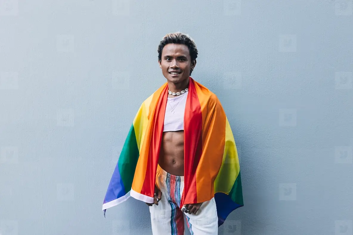 Young Smiling Male With LGBT Flag At Grey Wall Photo (269232 ...