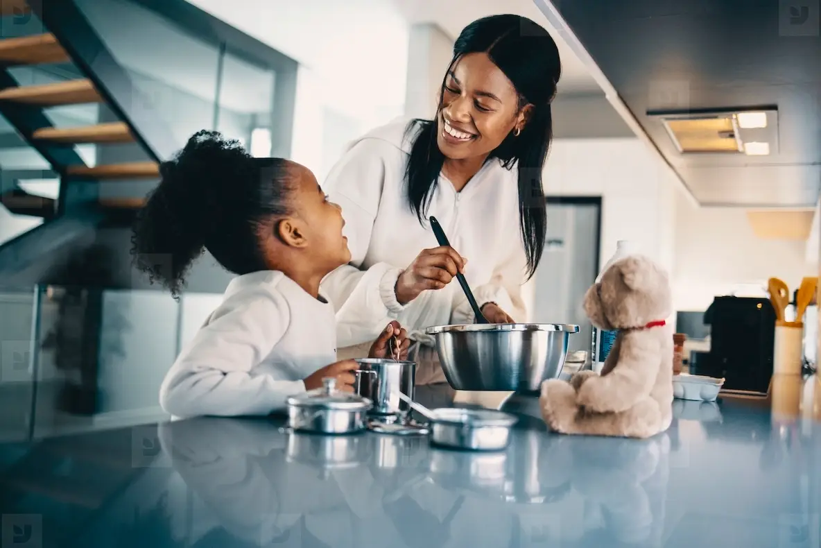 Little Girl Helping Her Mother With Making Food In The Kitchen Photo ...