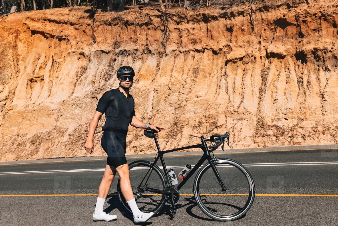 Professional Male Cyclist Walking With His Road Bike And Looking Away ...