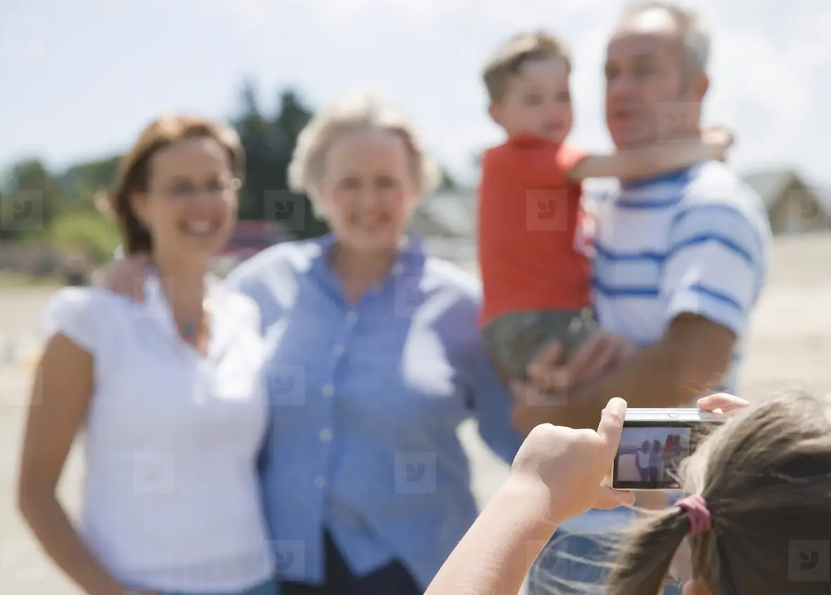 Back View Of Young Girl Taking Photograph Of Her Family Photo (278616 ...