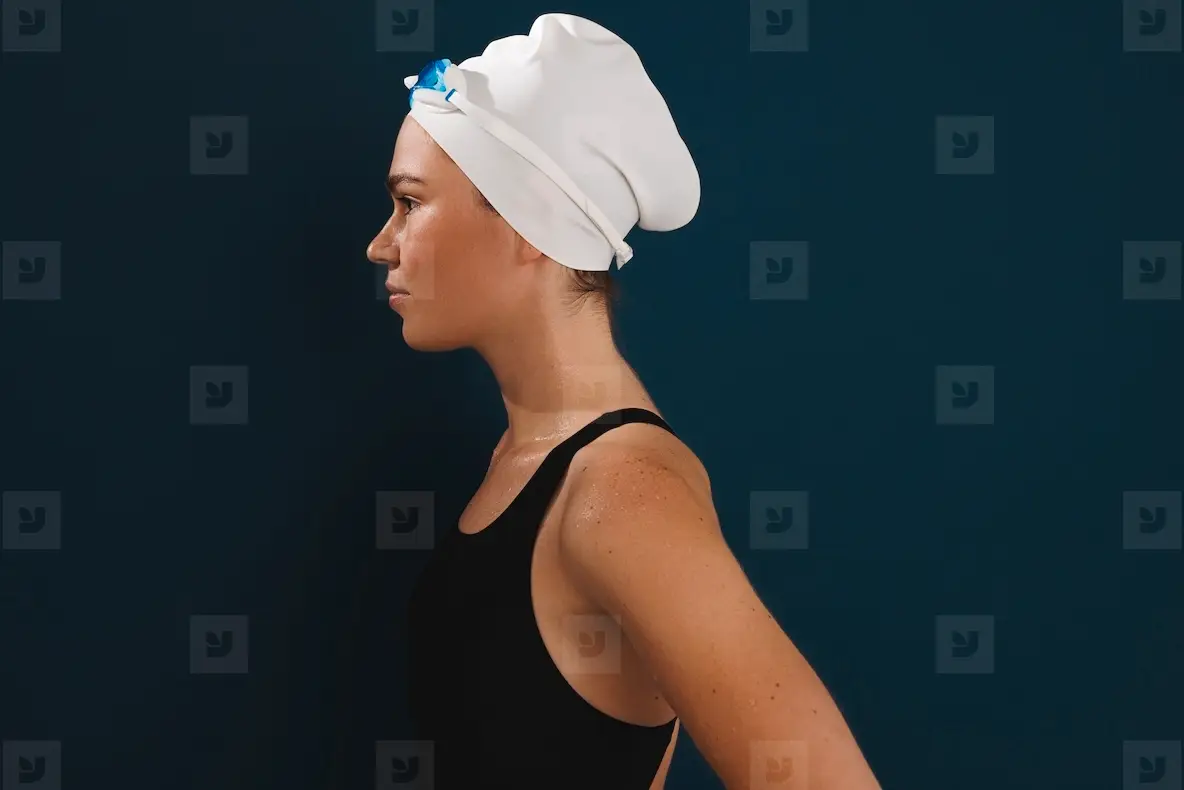 Side View Of A Woman Swimmer Standing At Blue Wall, Wearing Swimming ...