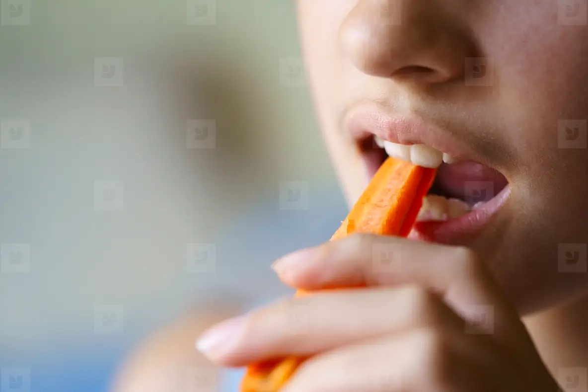 Anonymous Teenage Girl Biting Carrot Slice At Home Photo (283326 ...