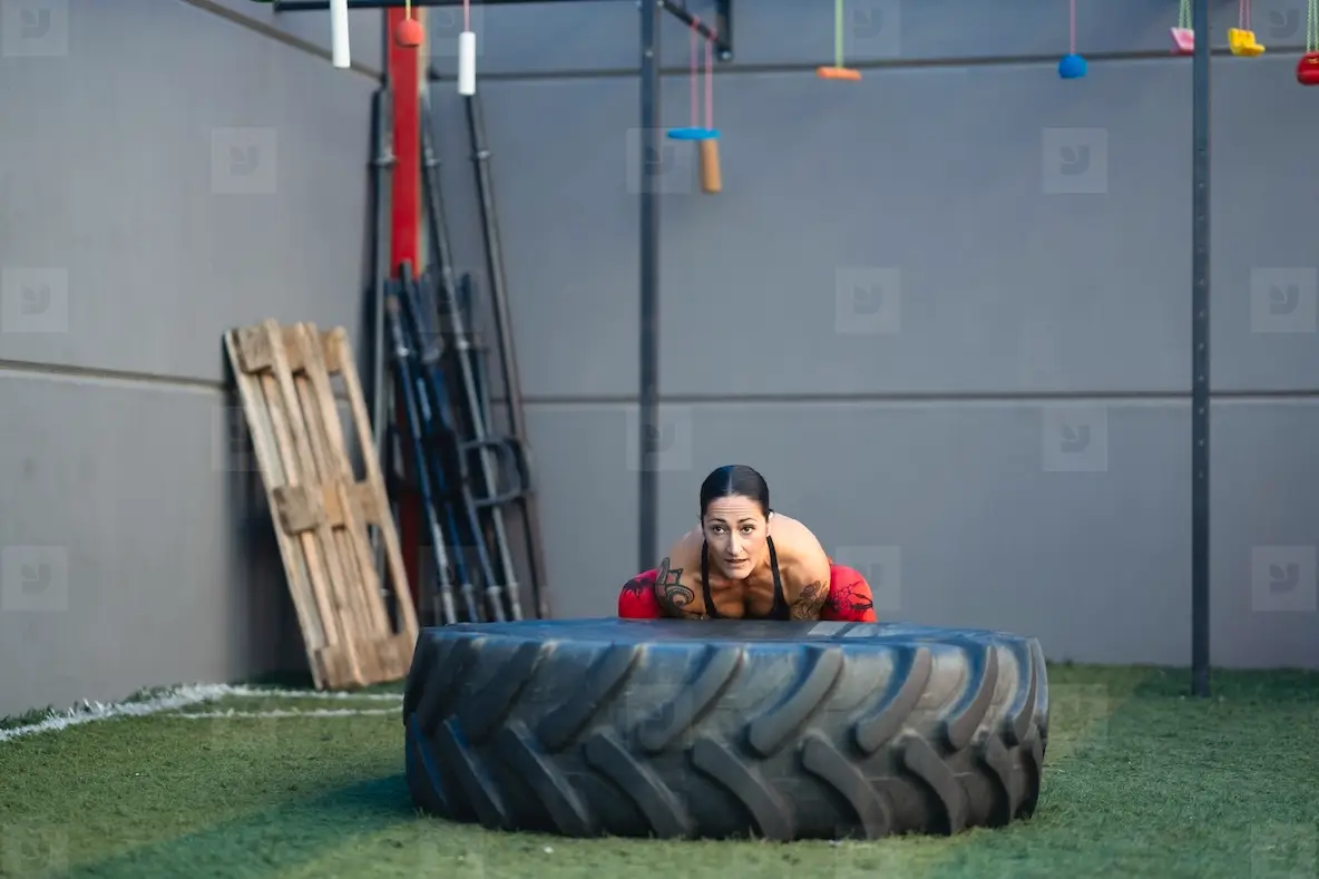 Strong Woman Working Out With A Wheel In A Gym Photo (283615 ...