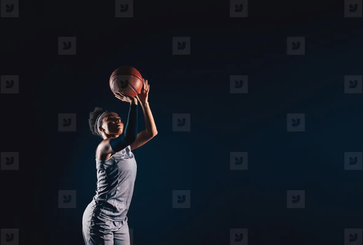 Professional Female Basketball Player Throwing Basketball Against Black ...