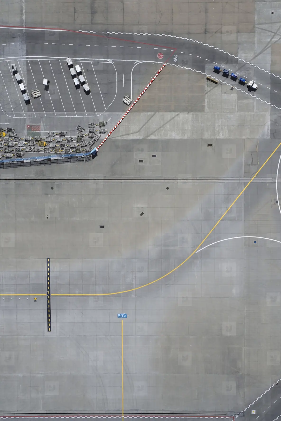 View From Above Luggage Carts And Road Markings On Sunny Airport Tarmac ...