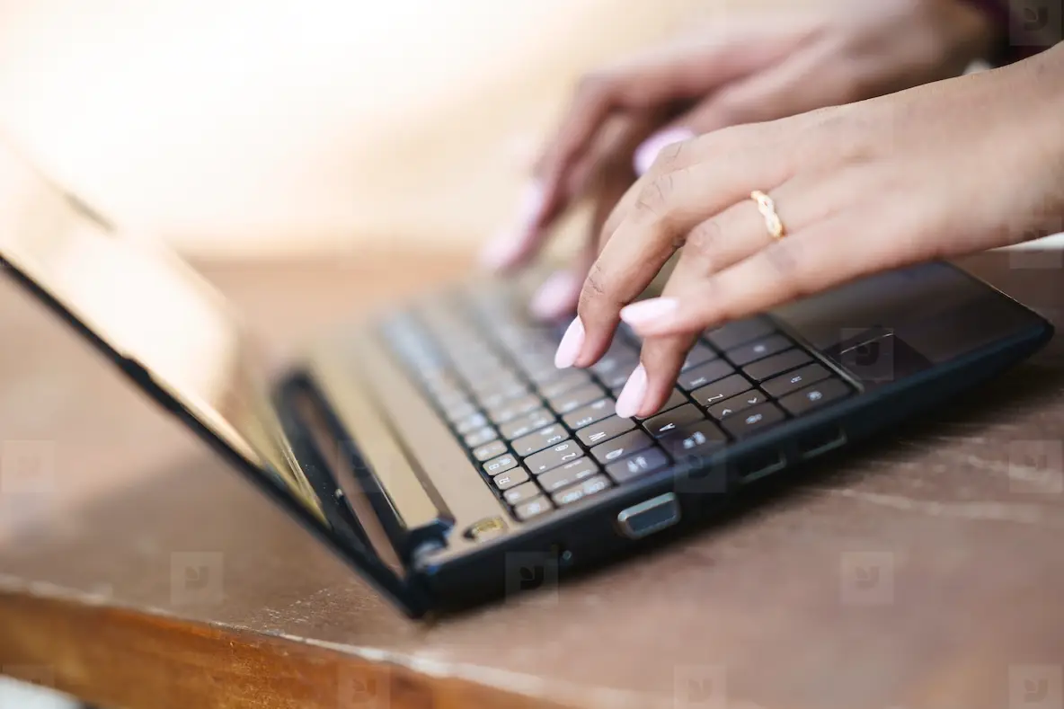 A Closeup Image Of Hands Actively Typing On A Laptop Keyboard Within A ...